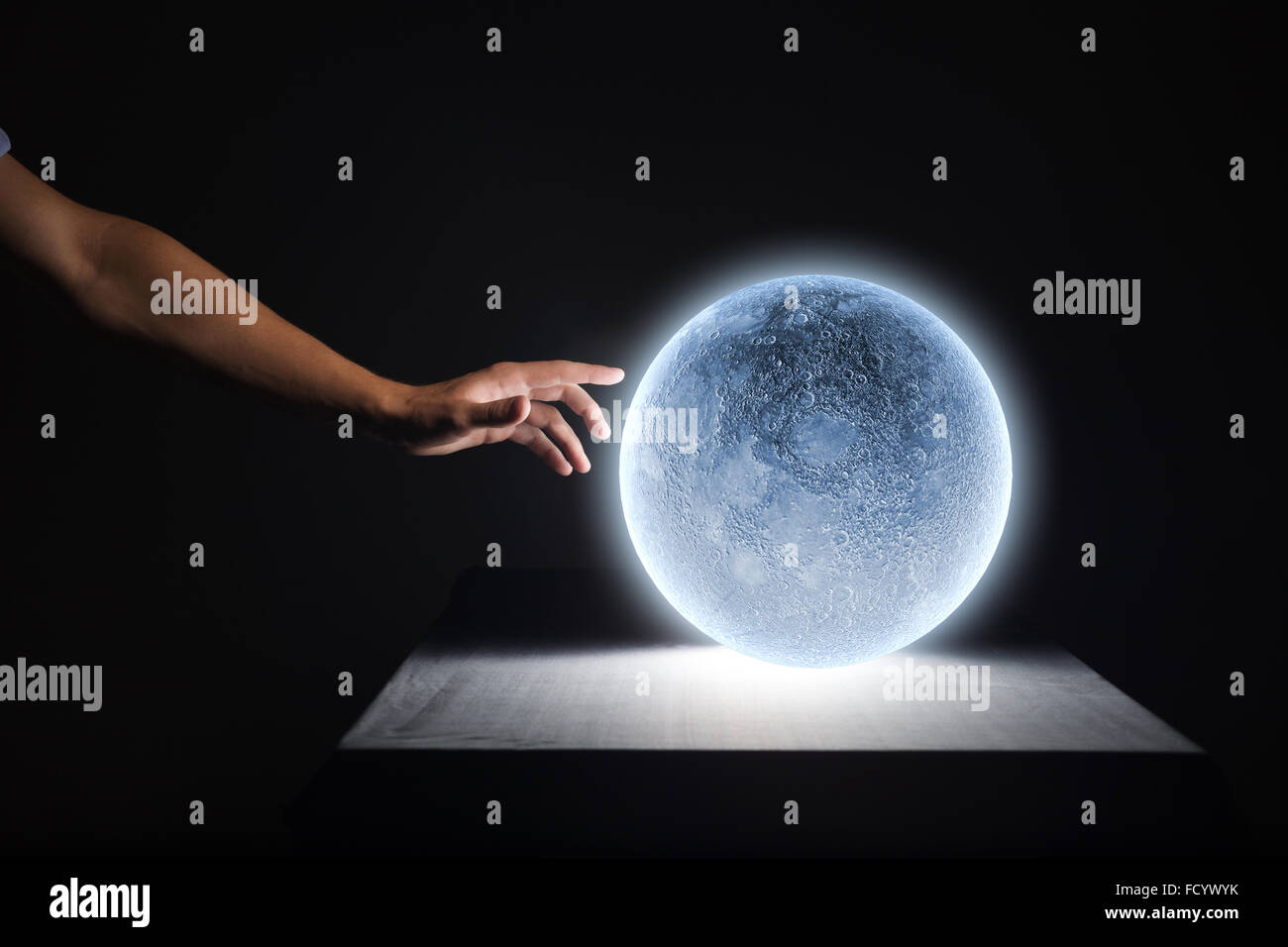 Close up of human hand touching blue glowing moon Stock Photo - Alamy