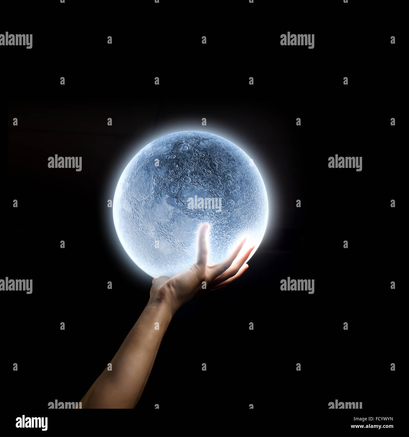 Close up of human hand holding blue glowing moon Stock Photo - Alamy