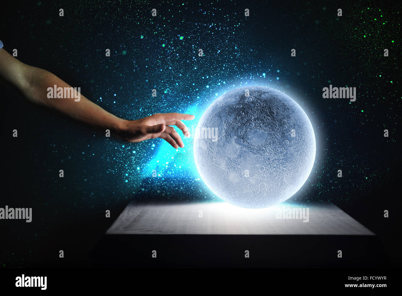 Close up of human hand touching blue glowing moon Stock Photo - Alamy