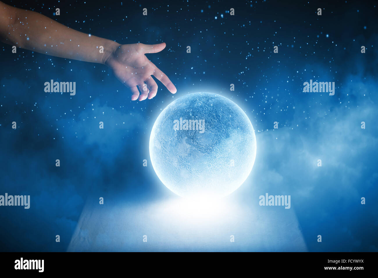Close up of human hand touching blue glowing moon Stock Photo - Alamy