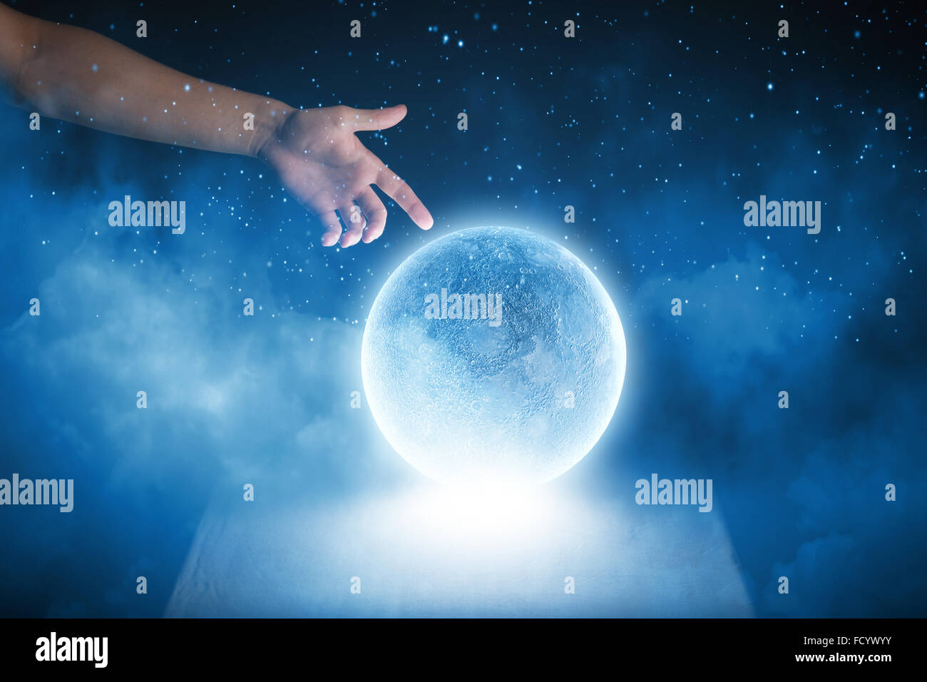 Close up of human hand touching blue glowing moon Stock Photo - Alamy