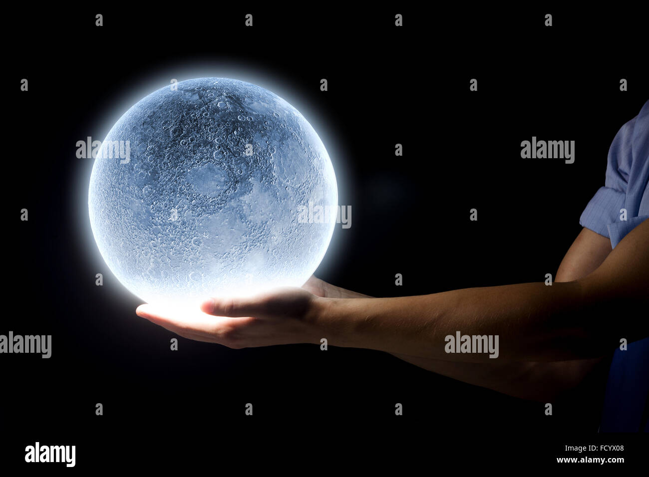 Close up of human hand holding blue glowing moon Stock Photo - Alamy