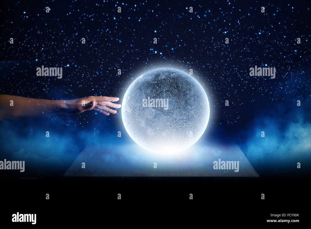 Close up of human hand touching blue glowing moon Stock Photo - Alamy
