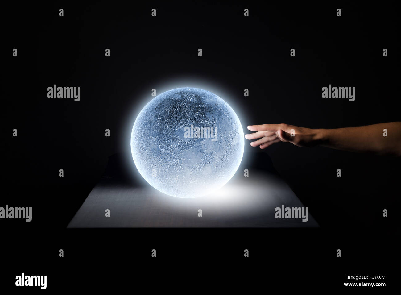Close up of human hand touching blue glowing moon Stock Photo - Alamy