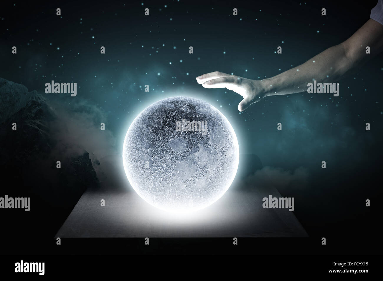 Close up of human hand touching blue glowing moon Stock Photo - Alamy