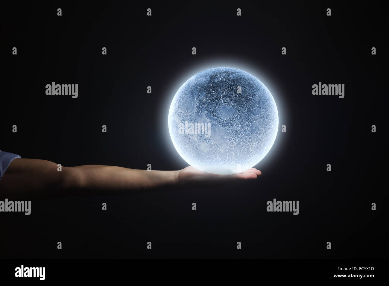 Close up of human hand holding blue glowing moon Stock Photo - Alamy