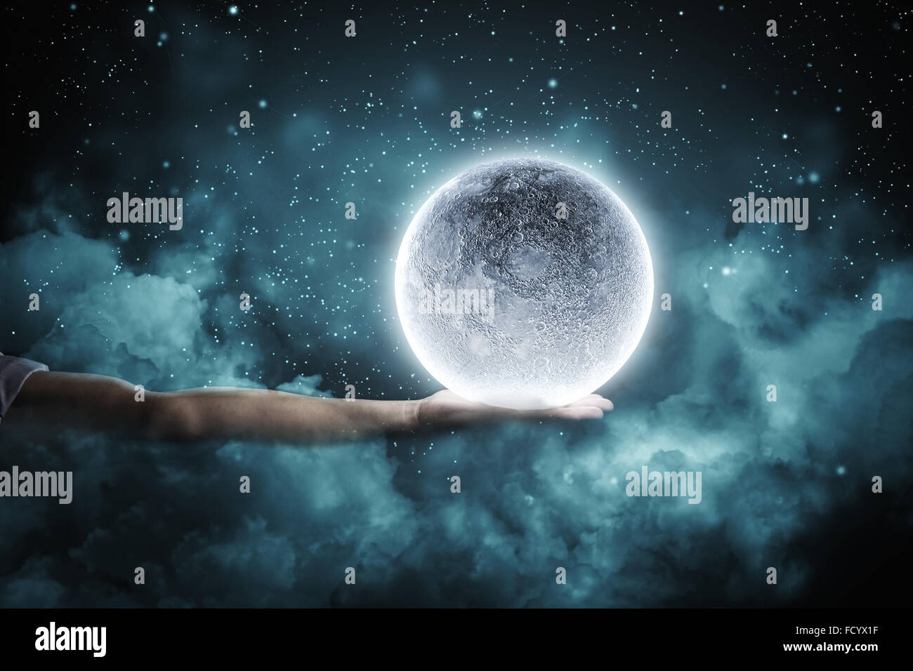 Close up of human hand holding blue glowing moon Stock Photo - Alamy