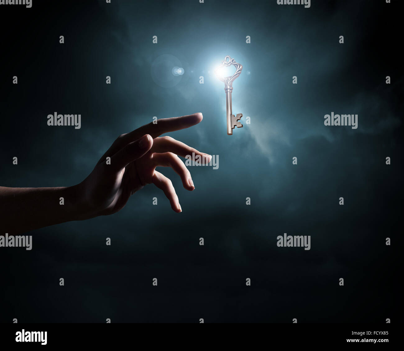 Close up of human hand holding key Stock Photo - Alamy