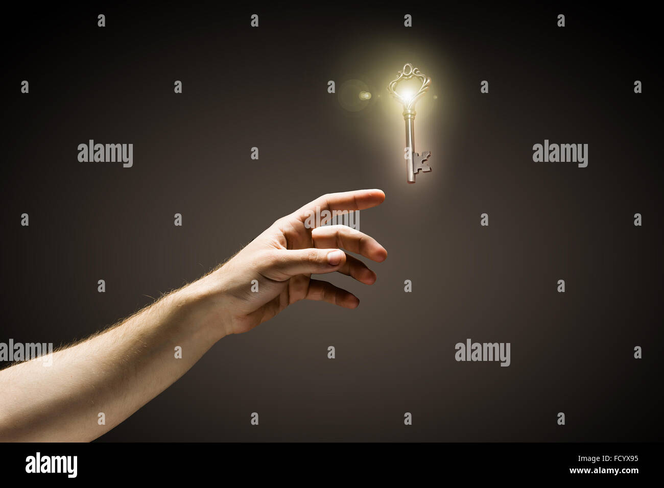 Close up of human hand holding key Stock Photo - Alamy
