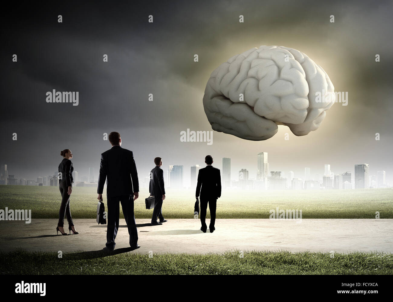 Huge human brain and many little businesspeople around Stock Photo - Alamy