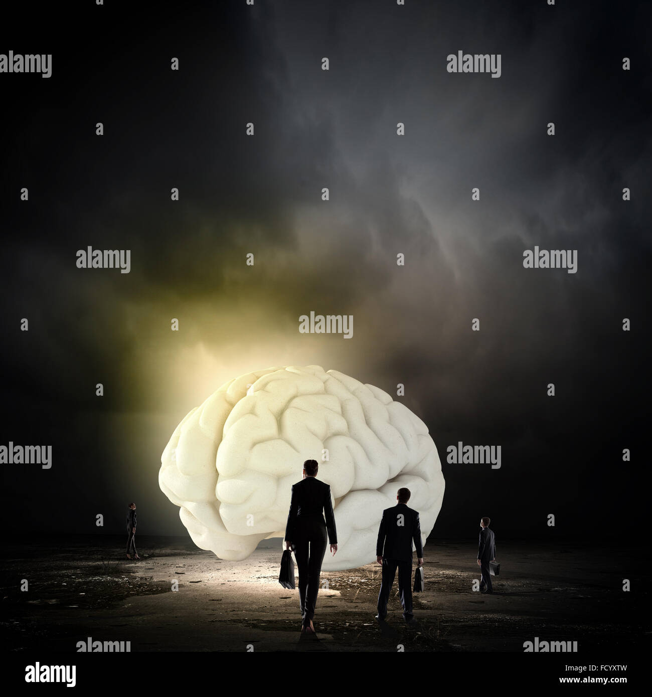 Huge human brain and many little businesspeople around Stock Photo - Alamy