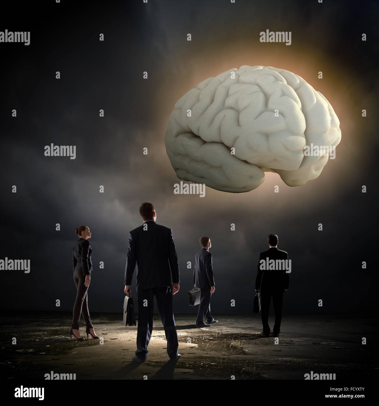 Huge human brain and many little businesspeople around Stock Photo - Alamy