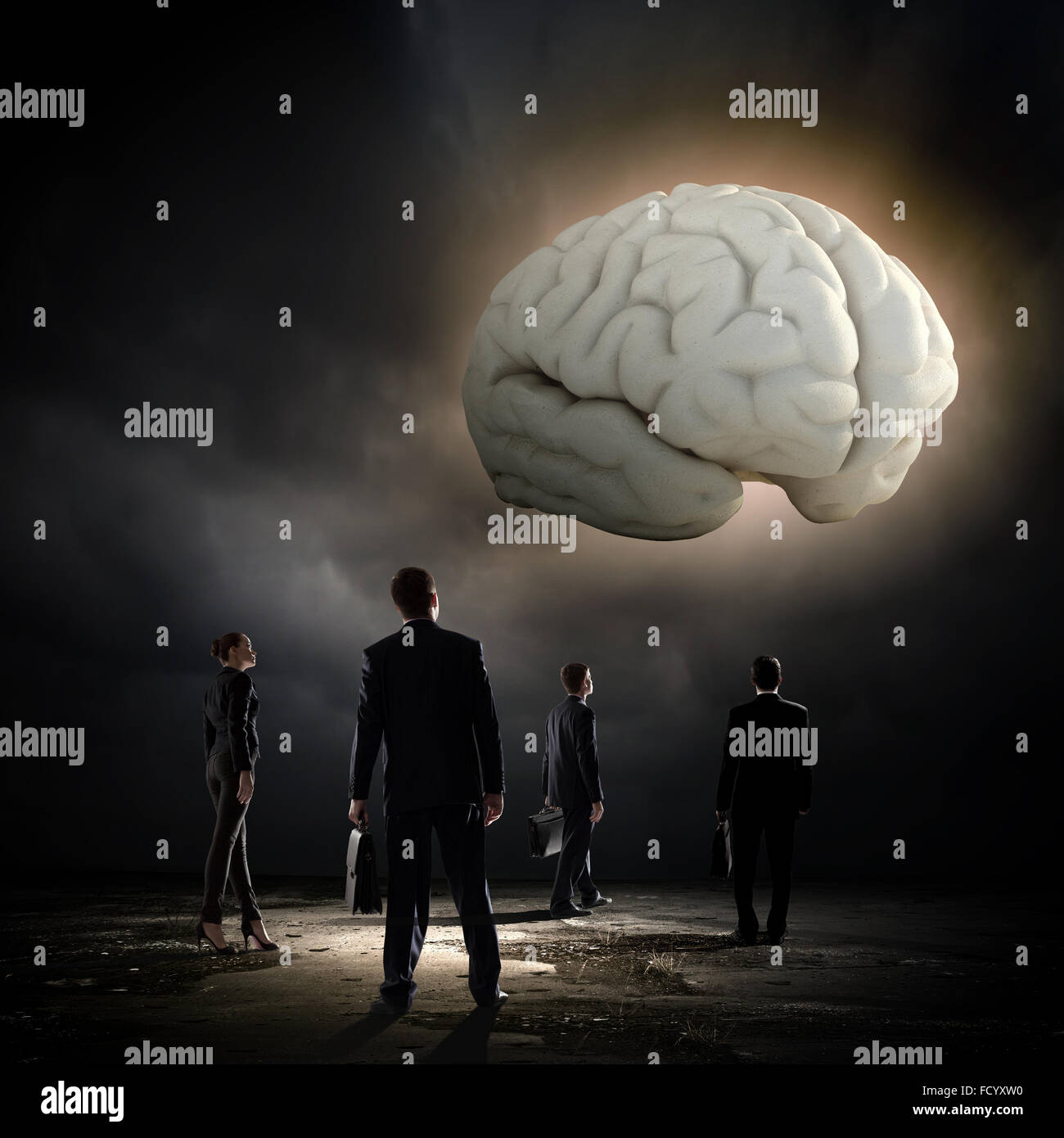Huge human brain and many little businesspeople around Stock Photo - Alamy