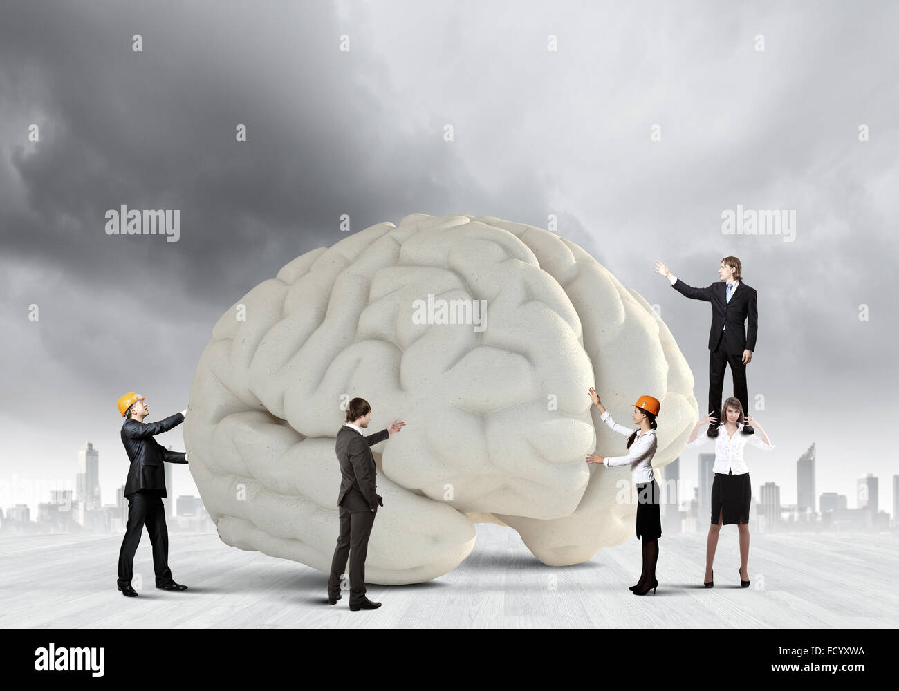 Huge human brain and many little businesspeople around Stock Photo - Alamy