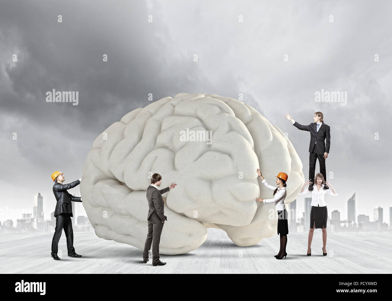 Huge human brain and many little businesspeople around Stock Photo - Alamy