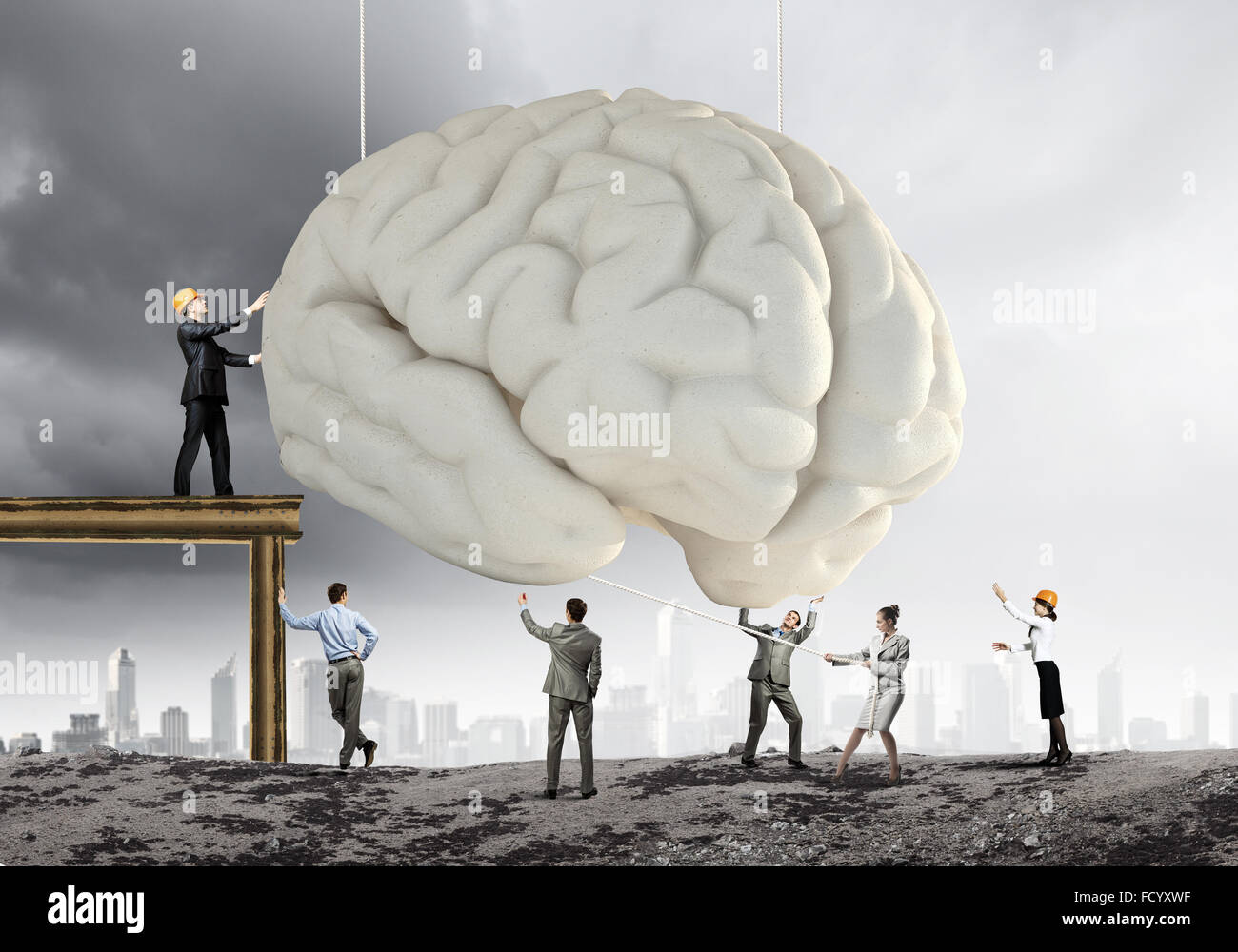 Huge human brain and many little businesspeople around Stock Photo - Alamy