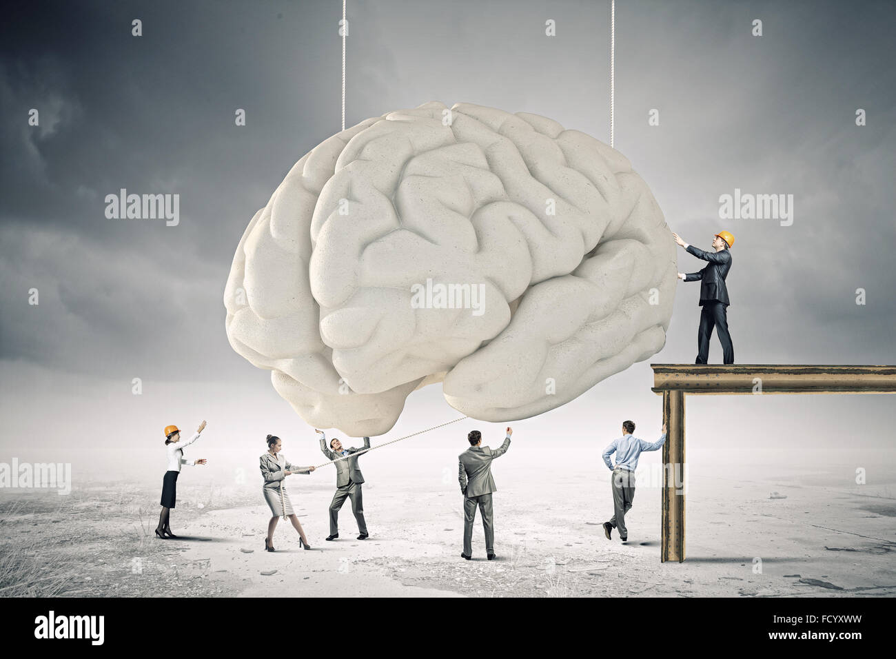 Huge human brain and many little businesspeople around Stock Photo - Alamy
