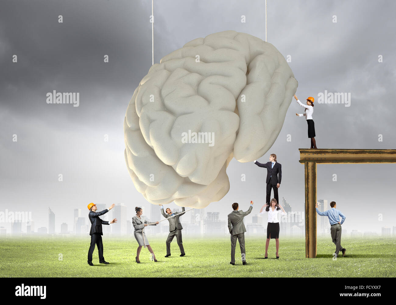 Huge human brain and many little businesspeople around Stock Photo - Alamy