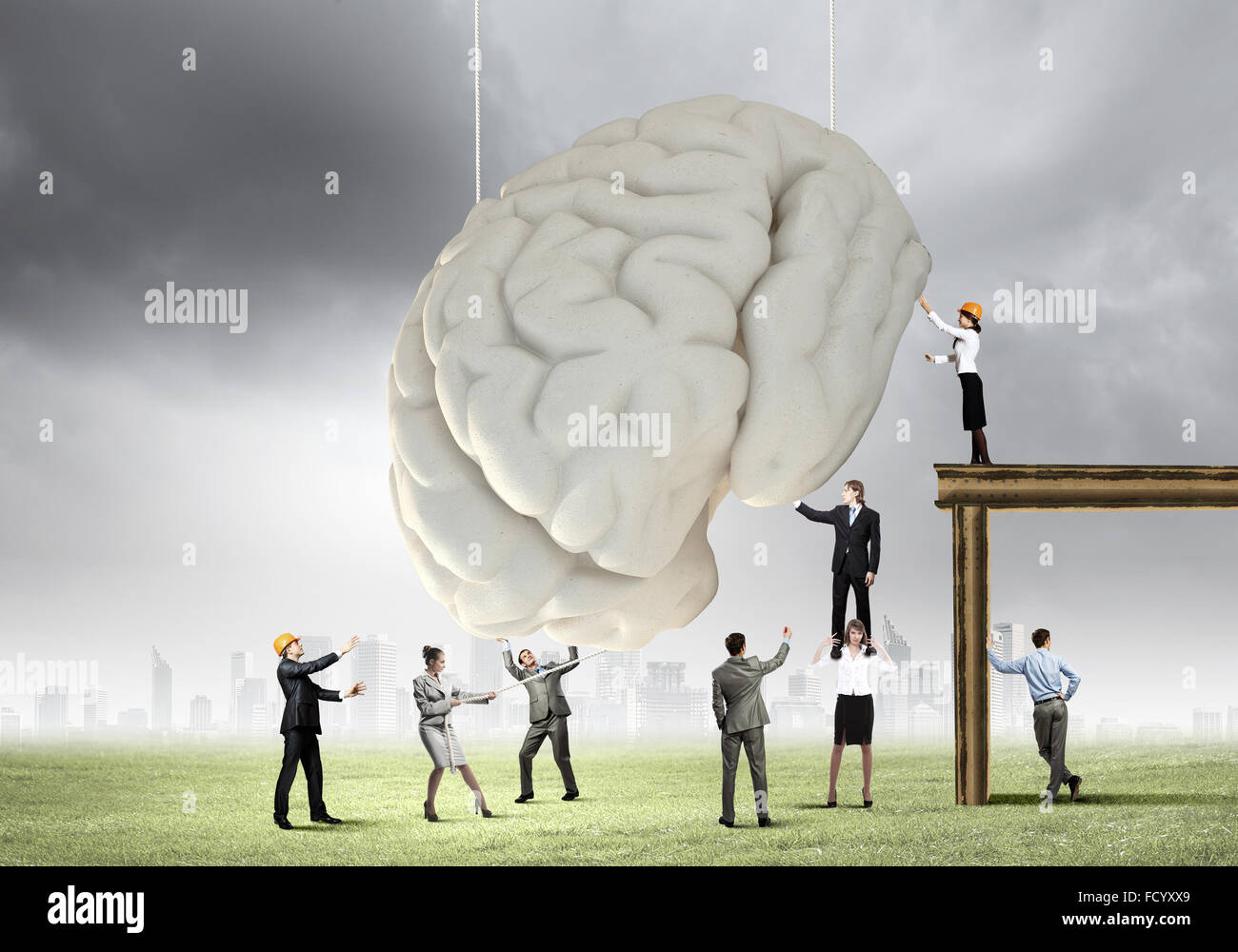 Huge human brain and many little businesspeople around Stock Photo - Alamy