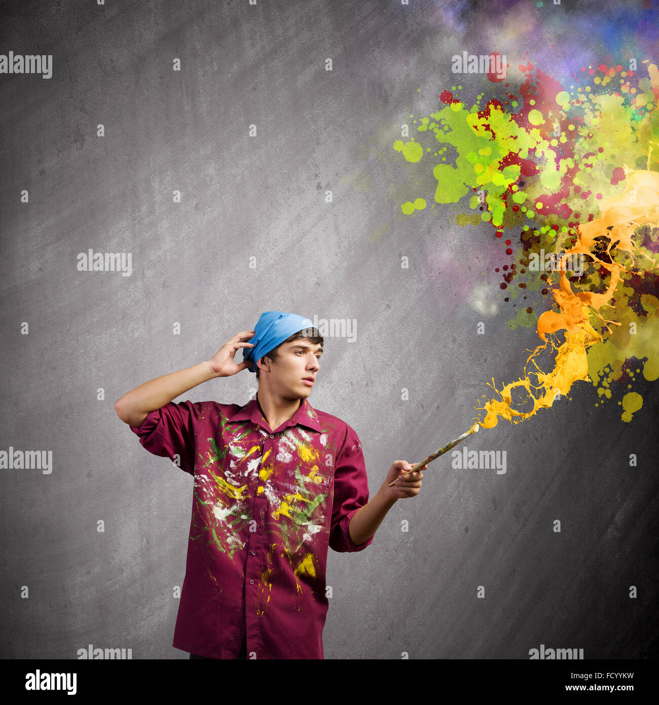 Young handsome man painter with brush in hand Stock Photo - Alamy