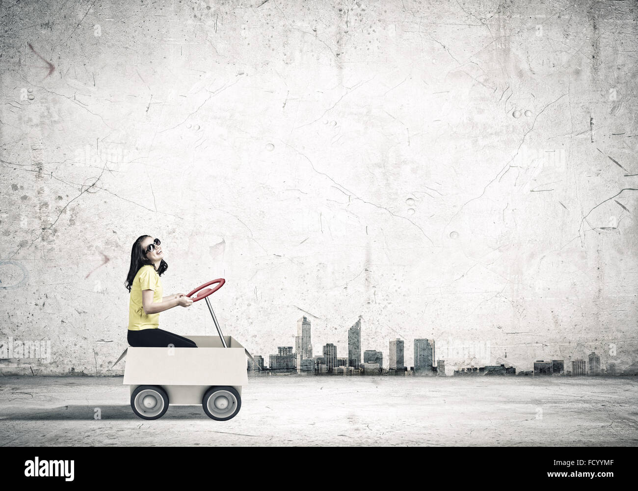 Young funny woman riding in carton box Stock Photo - Alamy