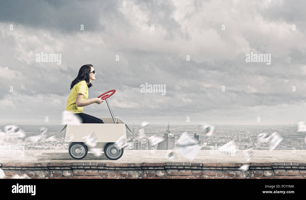 Young funny woman riding in carton box Stock Photo - Alamy