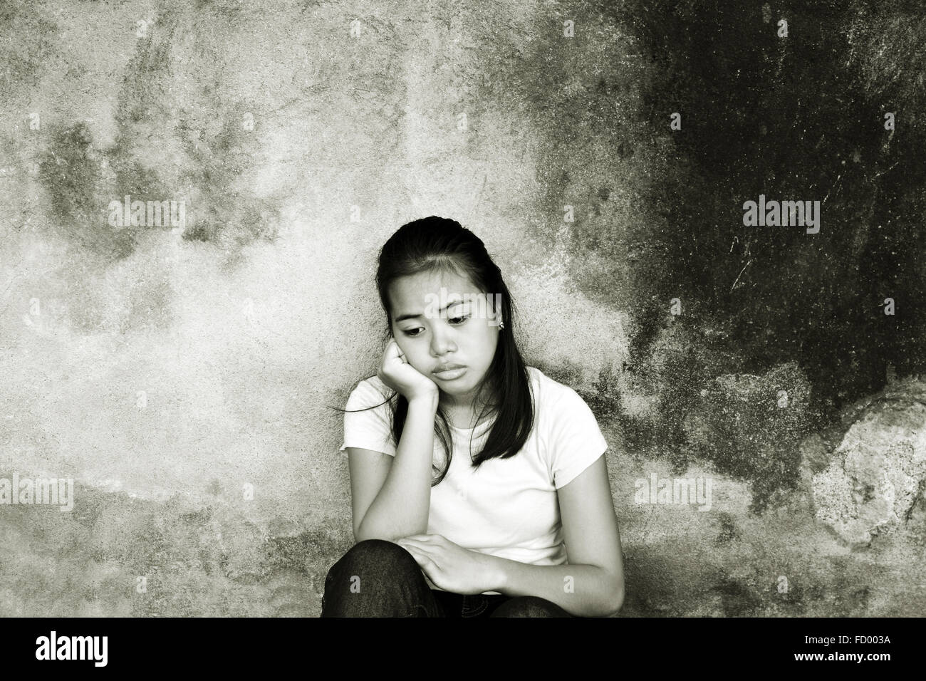 Sad teenager sitting alone in an abandoned place Stock Photo - Alamy