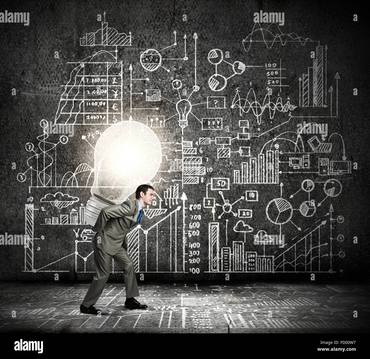 Young businessman carrying light bulb on his back Stock Photo - Alamy