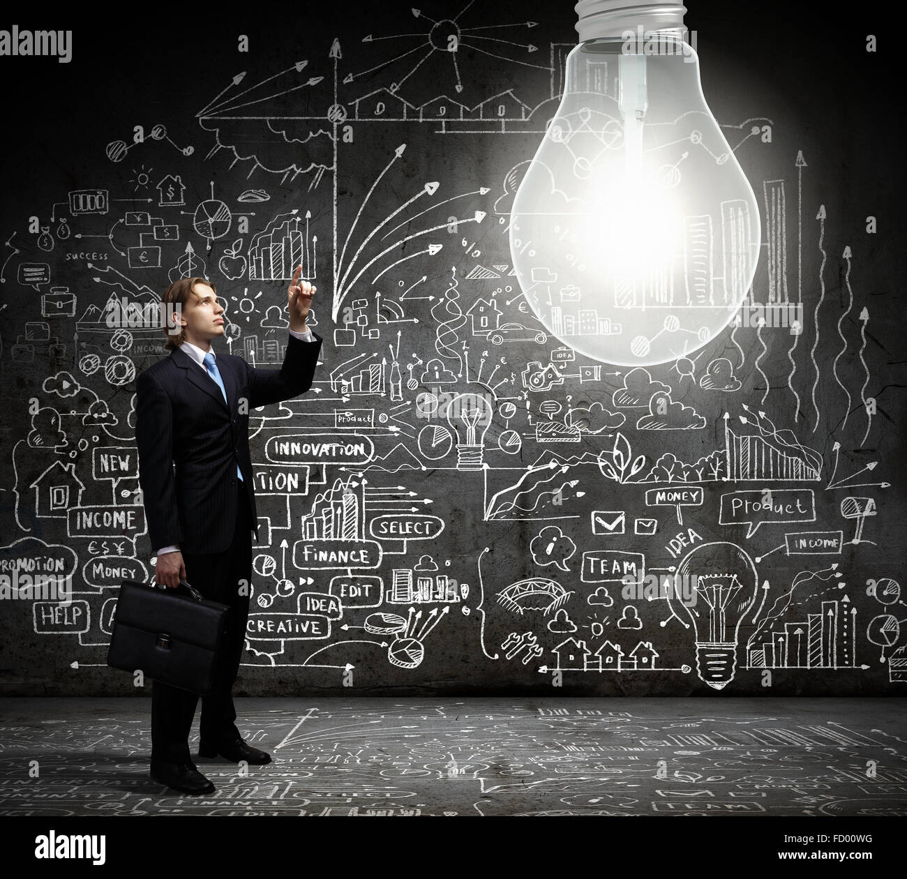 Businessman pointing at light bulb with business sketches at background ...