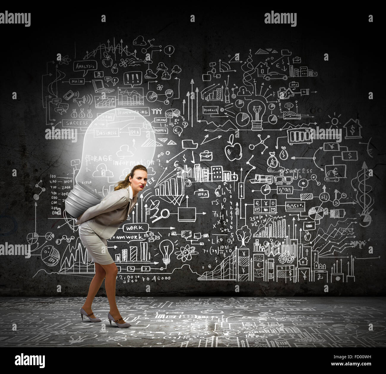 Young businesswoman carrying light bulb on back Stock Photo - Alamy