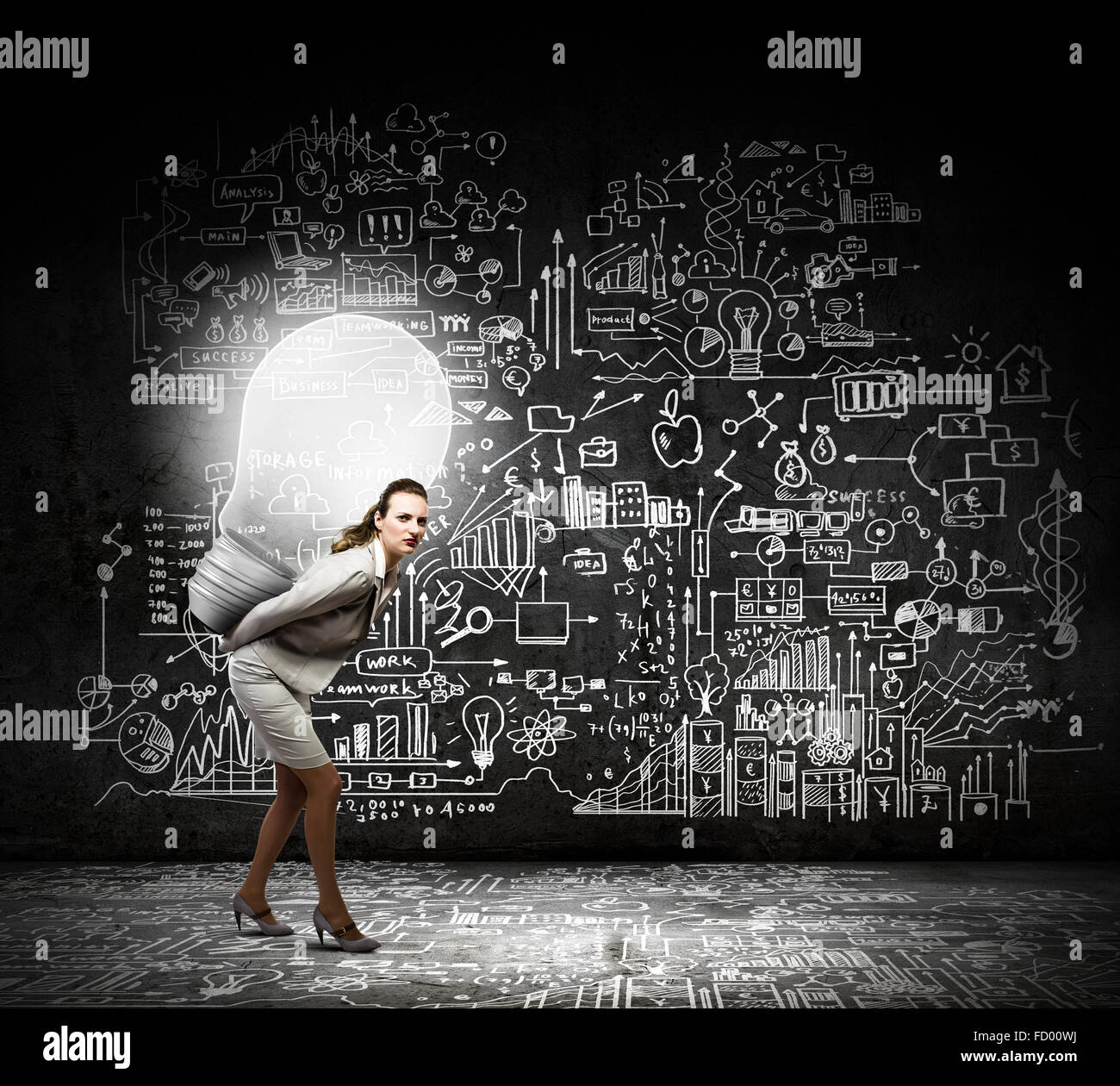 Young businesswoman carrying light bulb on back Stock Photo - Alamy