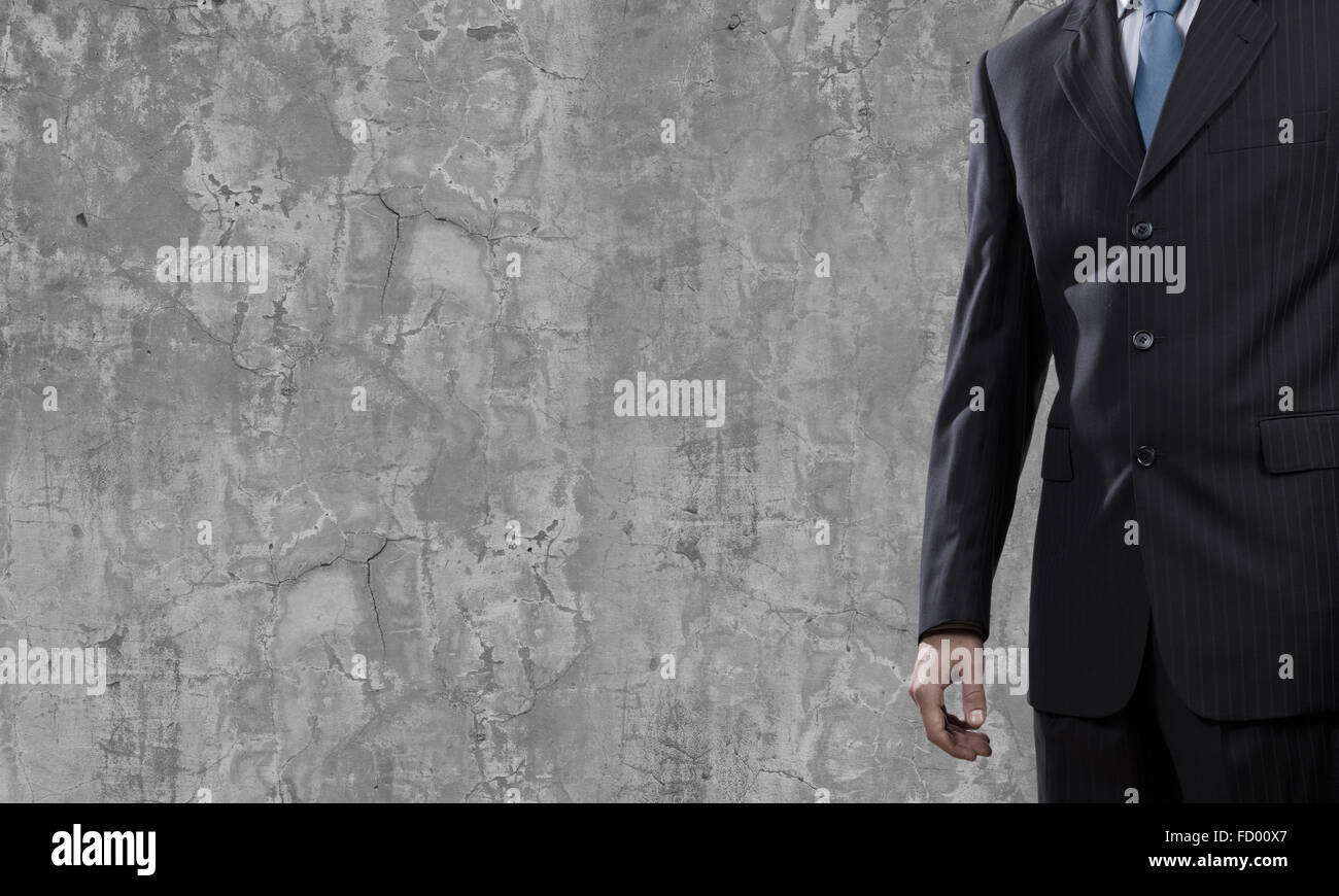 Close up of businessman body in suit against cement background Stock ...