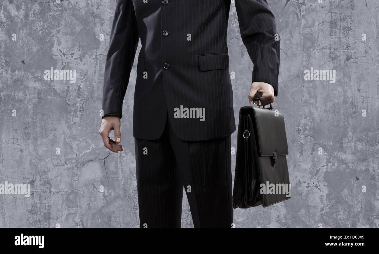 Close up of businessman body in suit against cement background Stock ...