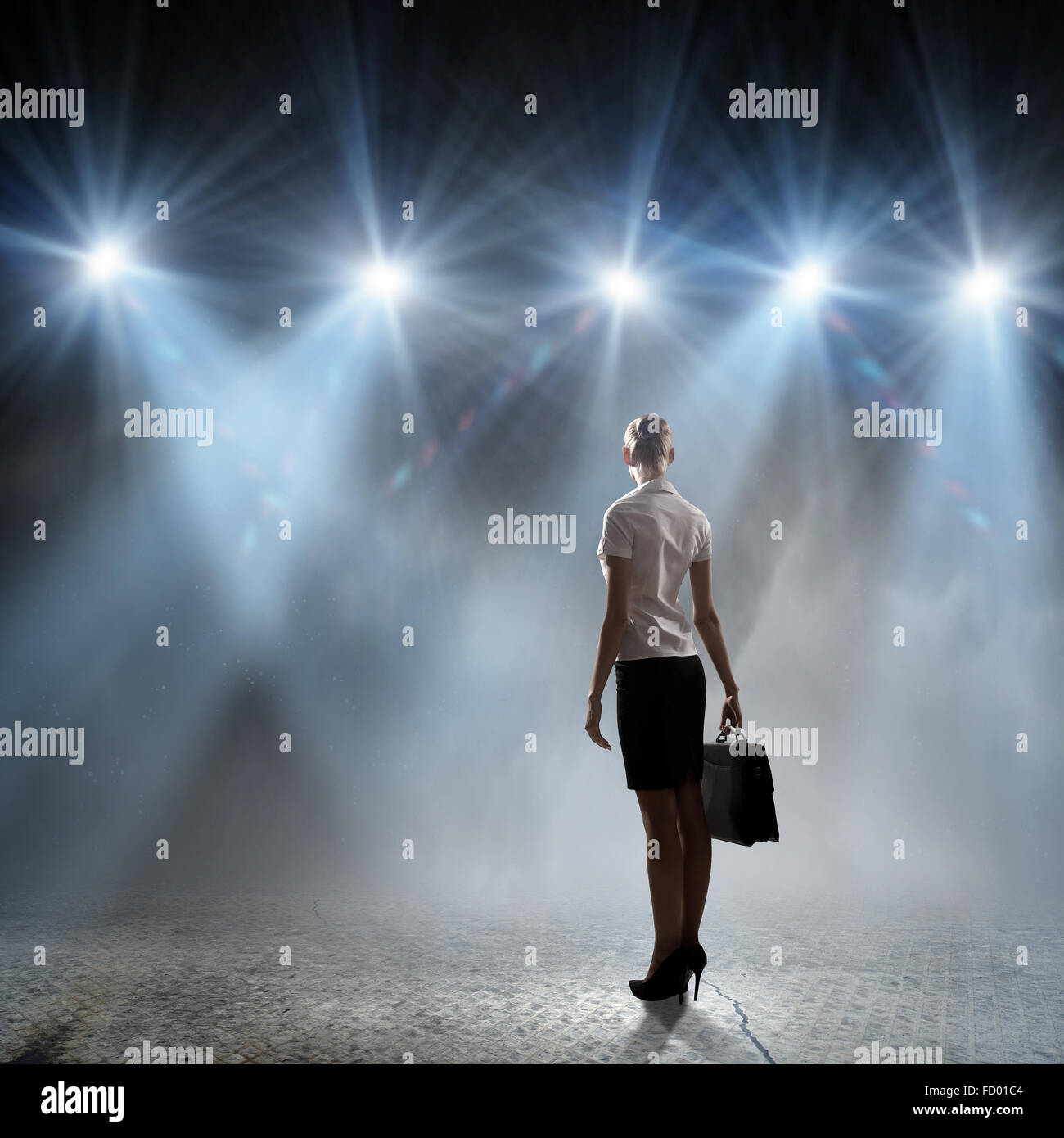 Rear view of businesswoman standing in lights of stage Stock Photo - Alamy