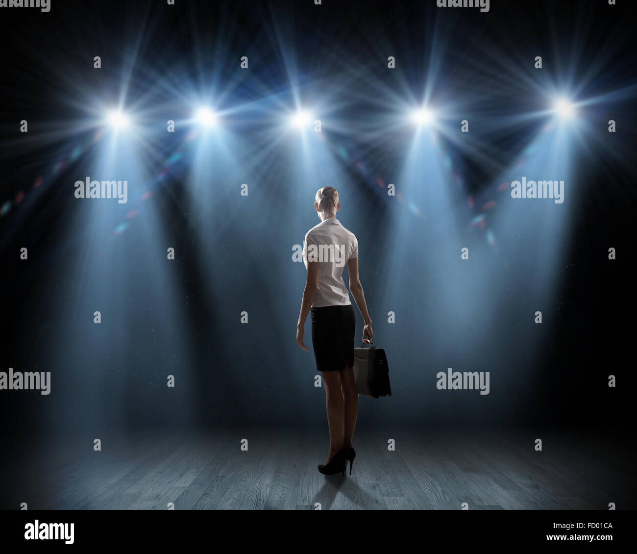 Rear view of businesswoman standing in lights of stage Stock Photo - Alamy