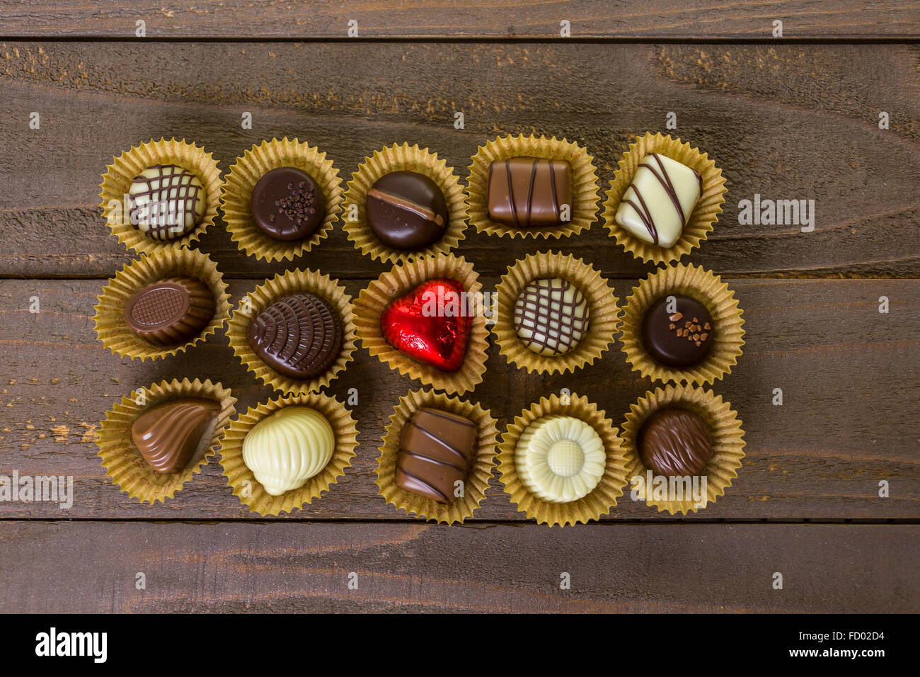 Assorted chocolated on wood table Stock Photo - Alamy