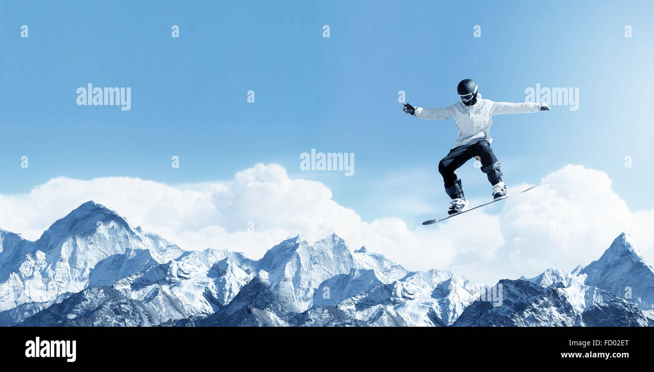 Snowboarder making jump high in clear sky Stock Photo - Alamy