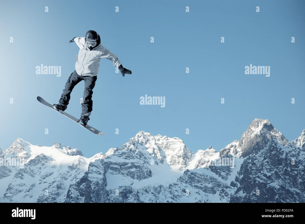 Snowboarder making jump high in clear sky Stock Photo - Alamy