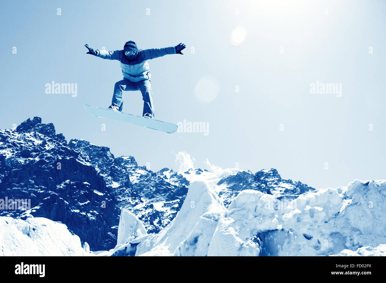 Snowboarder making jump high in clear sky Stock Photo - Alamy