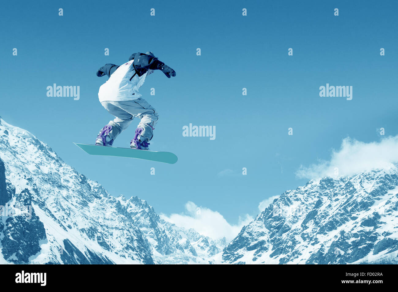 Snowboarder making jump high in clear sky Stock Photo - Alamy