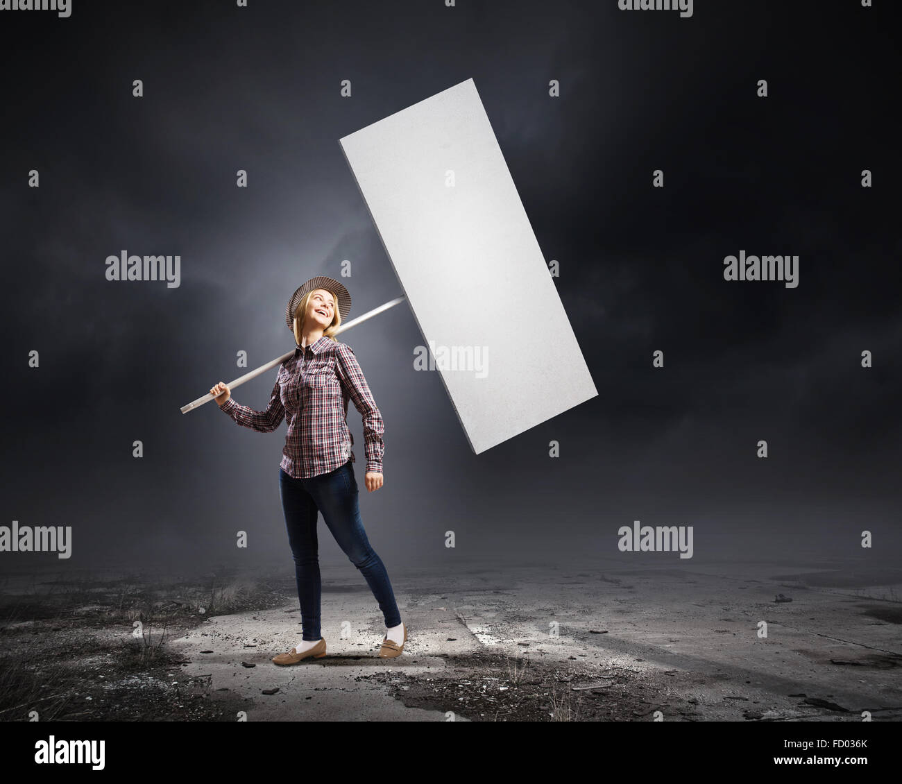 Young woman in casual carrying white blank banner Stock Photo - Alamy