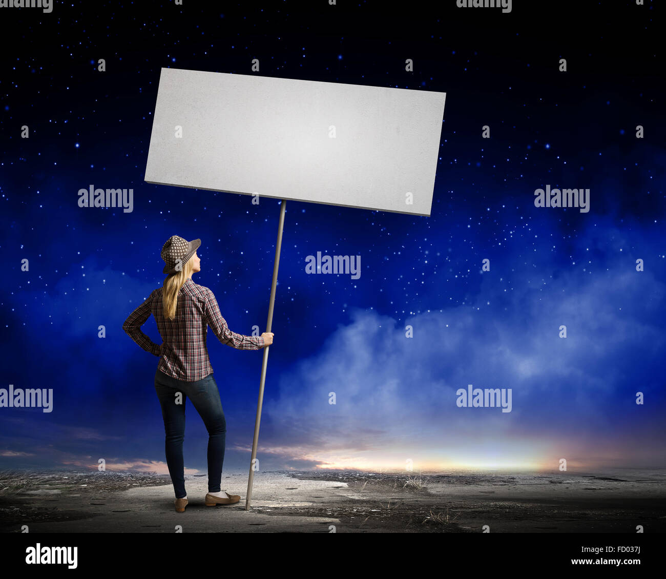 Young woman in casual carrying white blank banner Stock Photo - Alamy