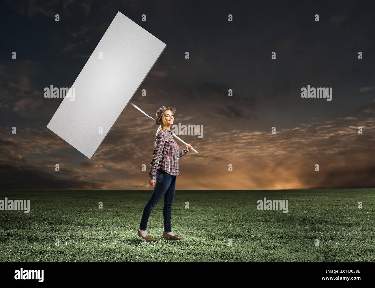 Young woman in casual carrying white blank banner Stock Photo - Alamy