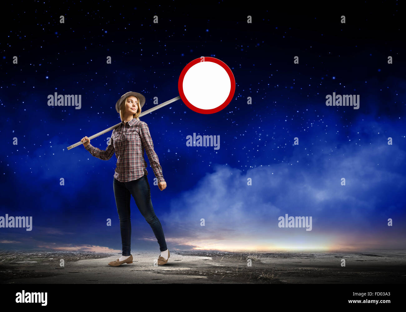 Young woman in casual holding road sign Stock Photo - Alamy