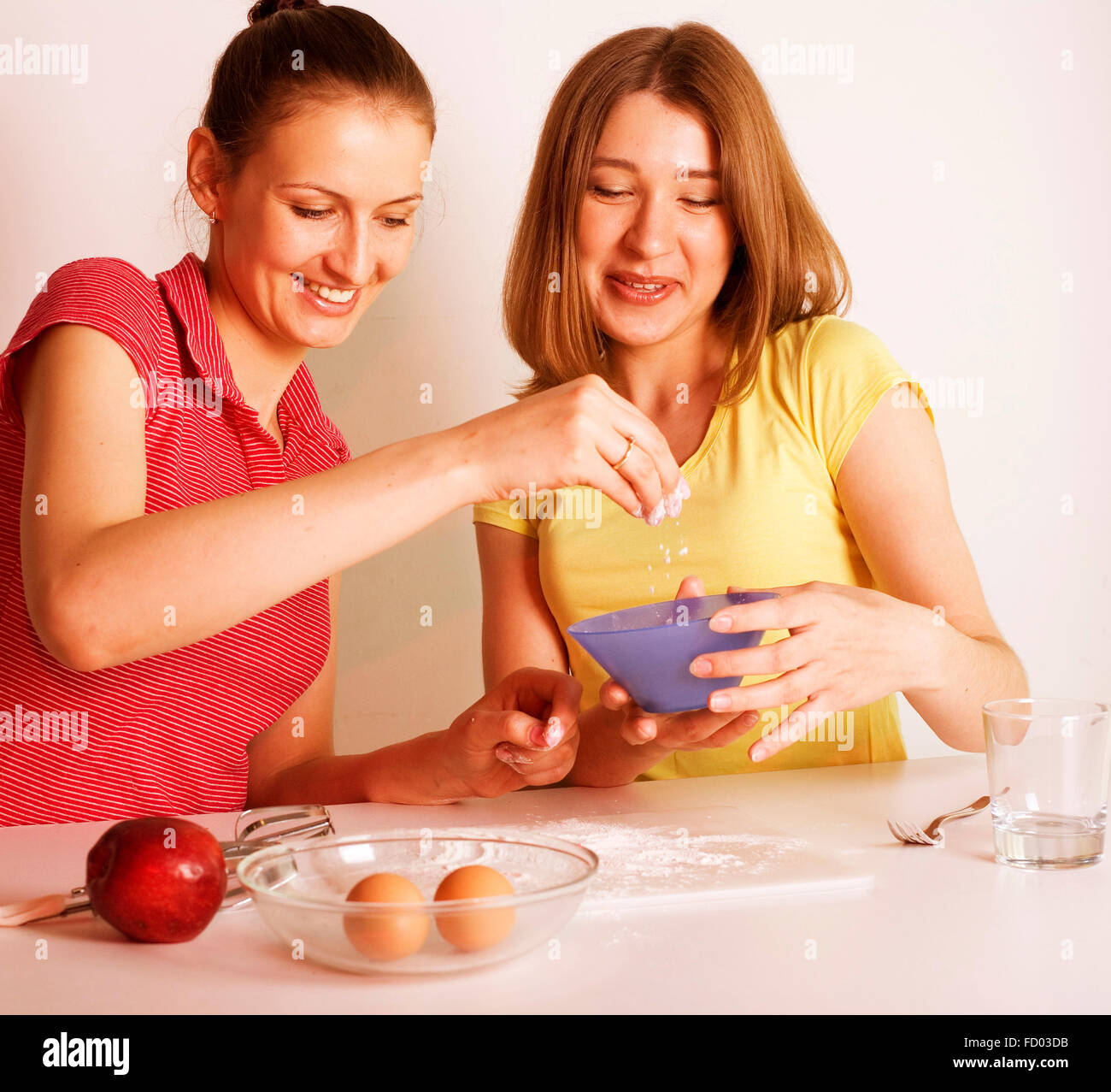 two woman friend cooking food together, having fun Stock Photo - Alamy