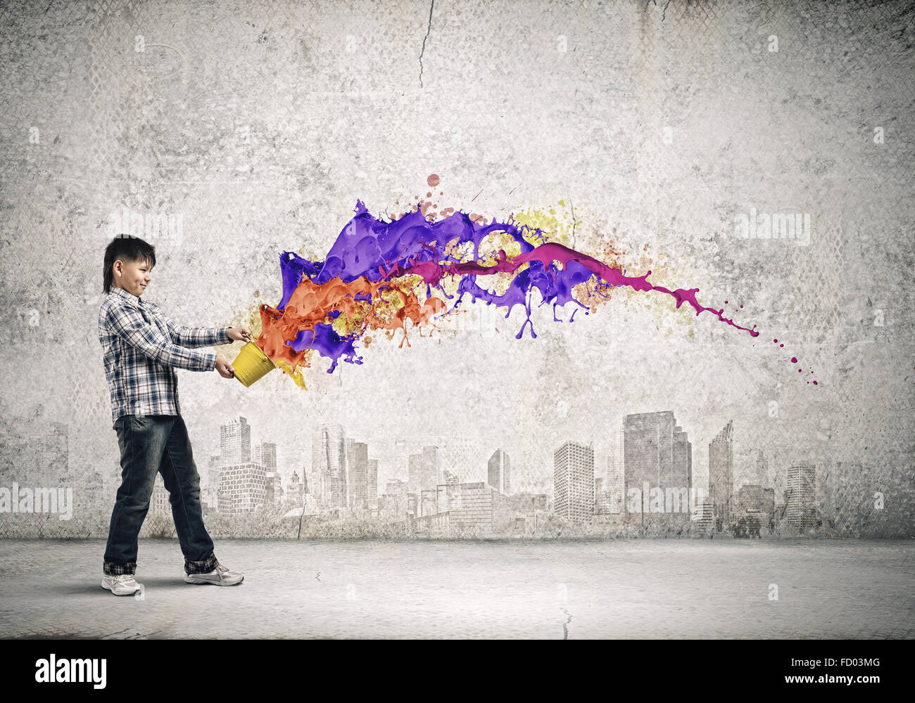 Cute boy splashing colorful paint from bucket Stock Photo - Alamy