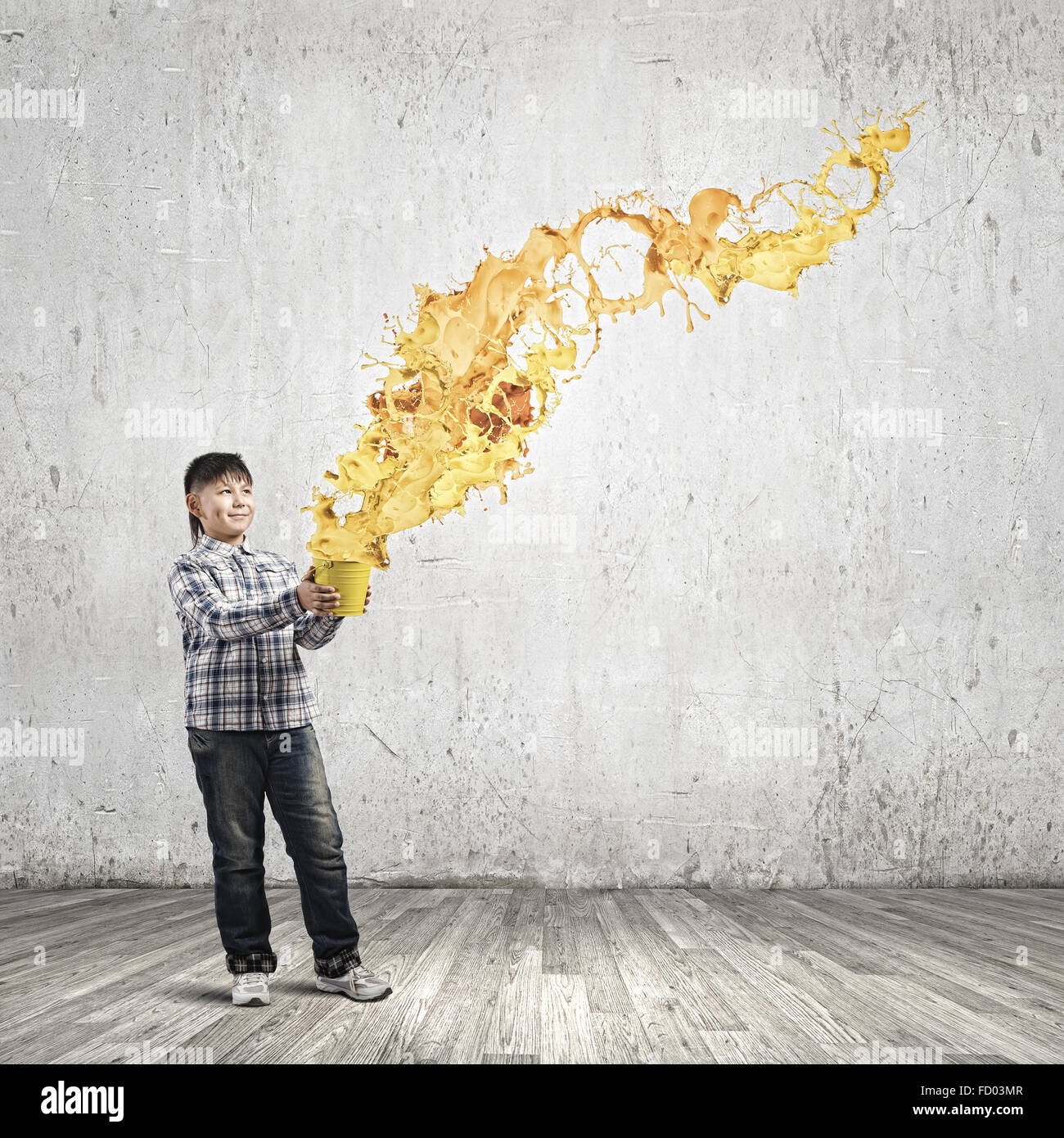Cute boy splashing colorful paint from bucket Stock Photo - Alamy