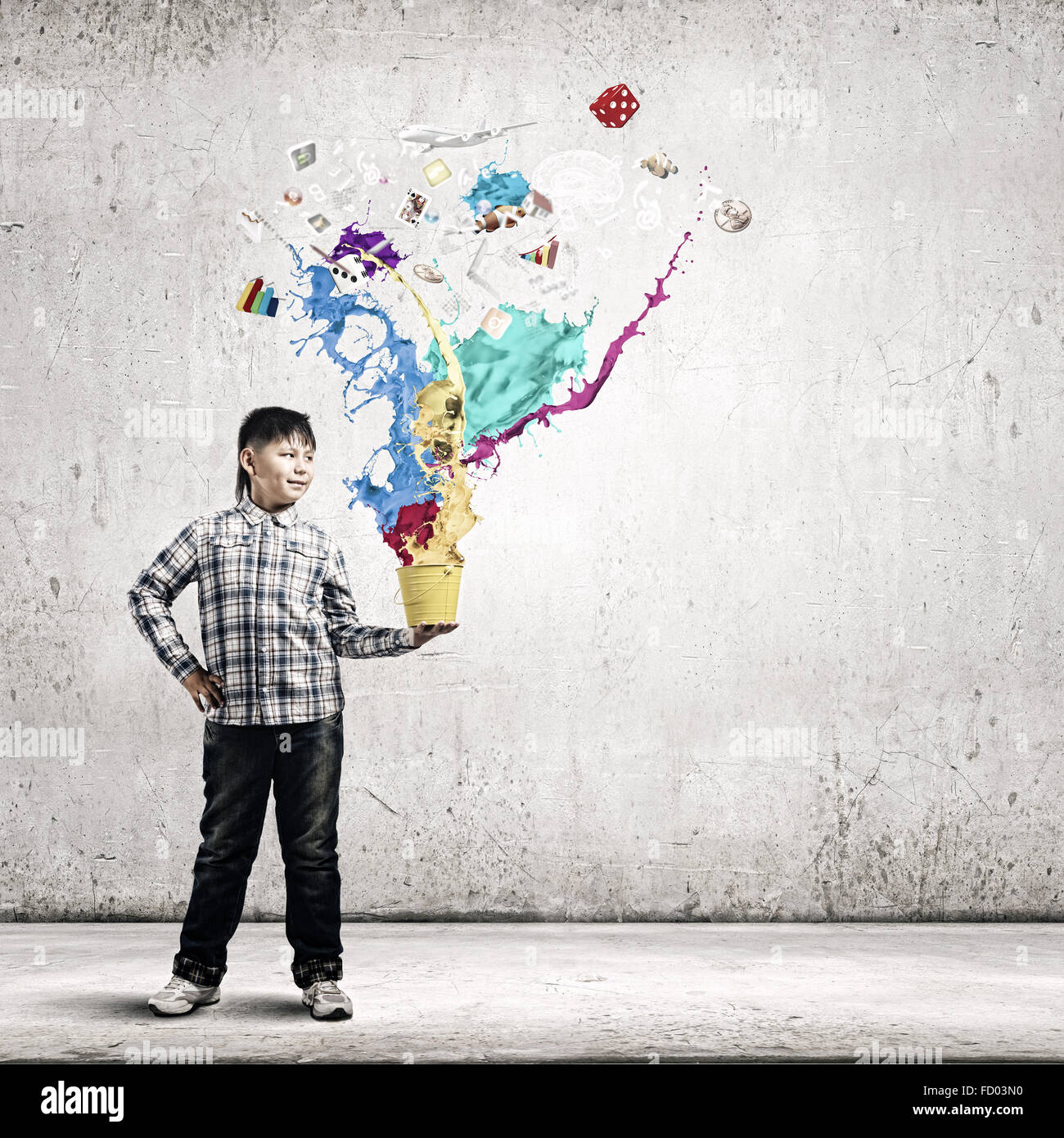 Cute boy splashing colorful paint from bucket Stock Photo - Alamy