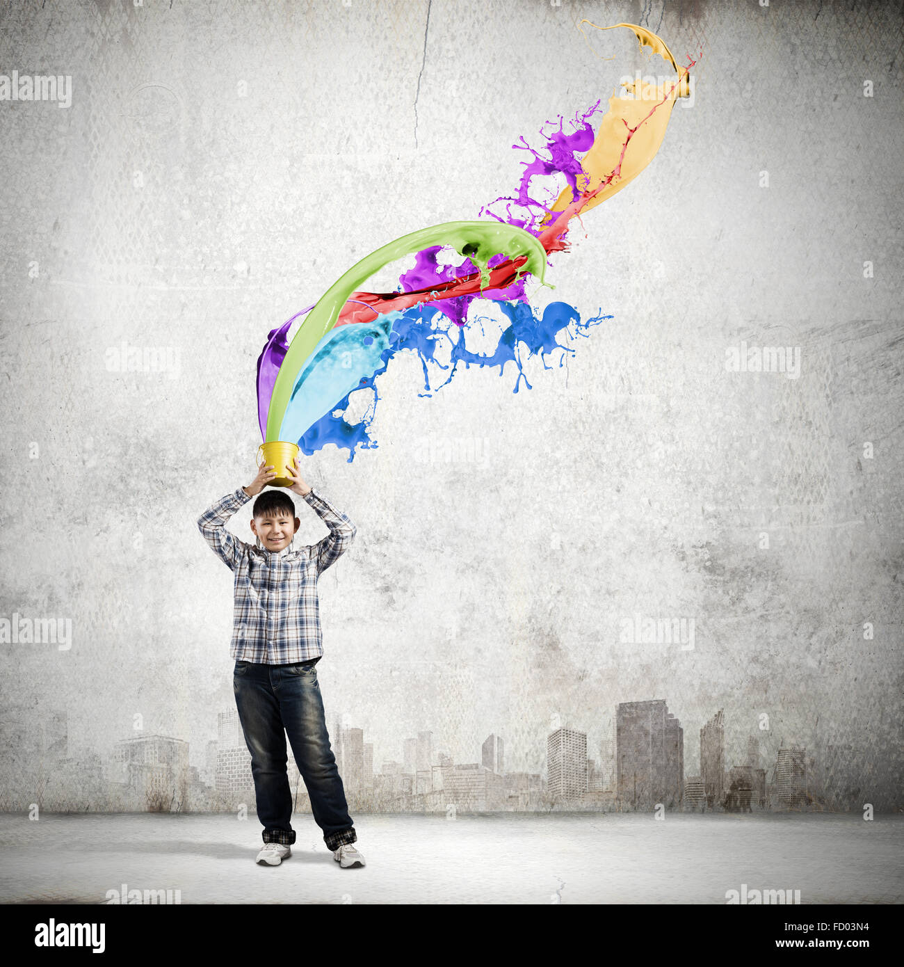 Cute boy splashing colorful paint from bucket Stock Photo - Alamy