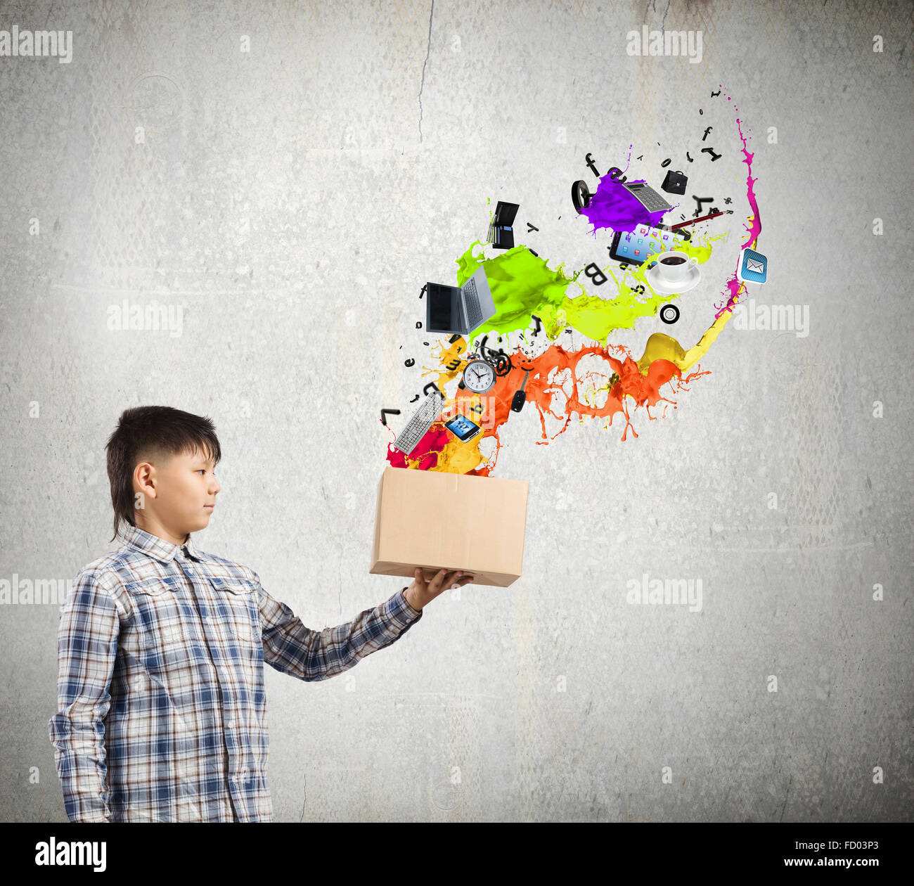 Cute boy splashing colorful paint from carton box Stock Photo - Alamy
